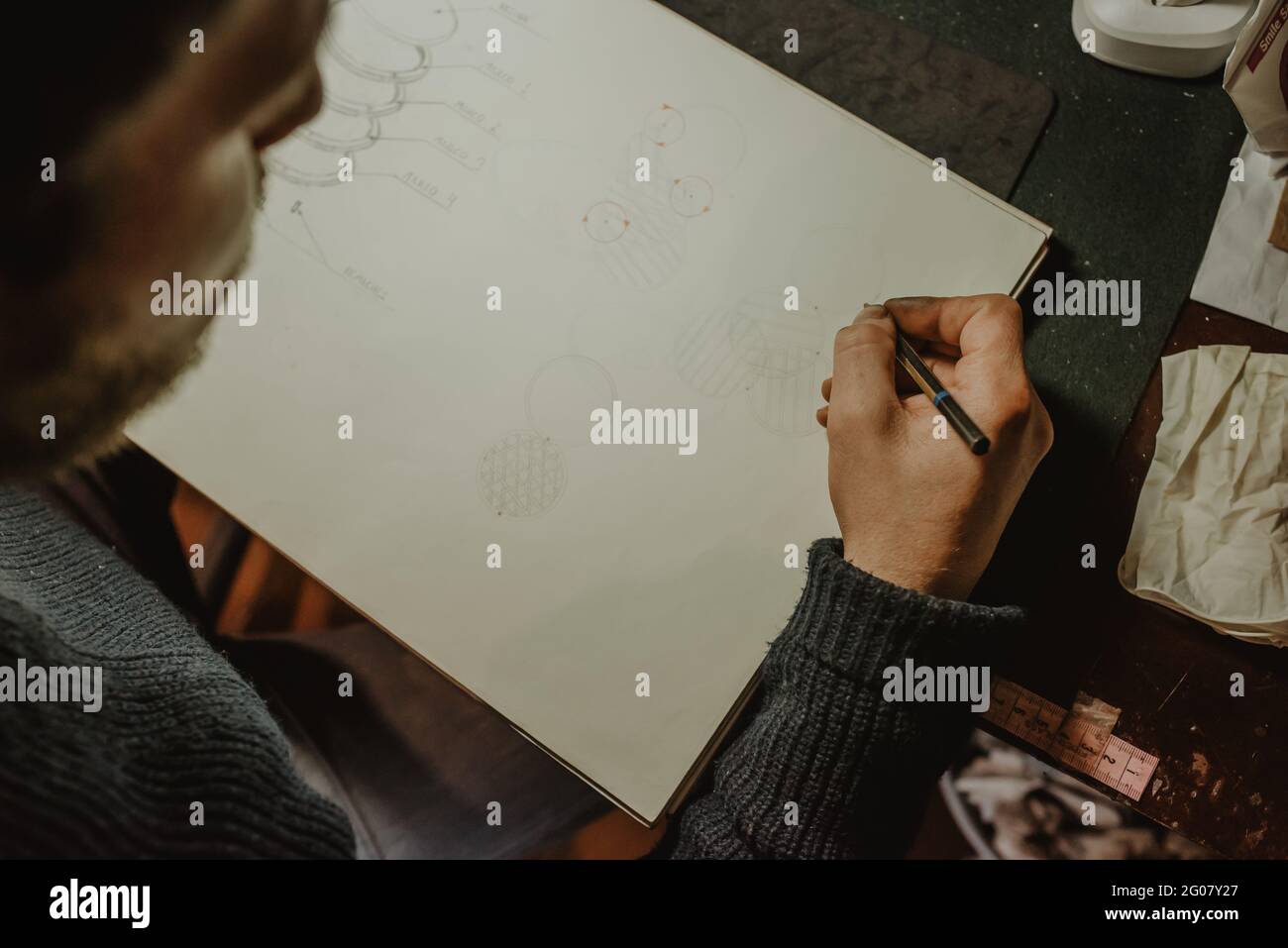 Crop goldsmith drawing ring sketch in open notepad while working in ...