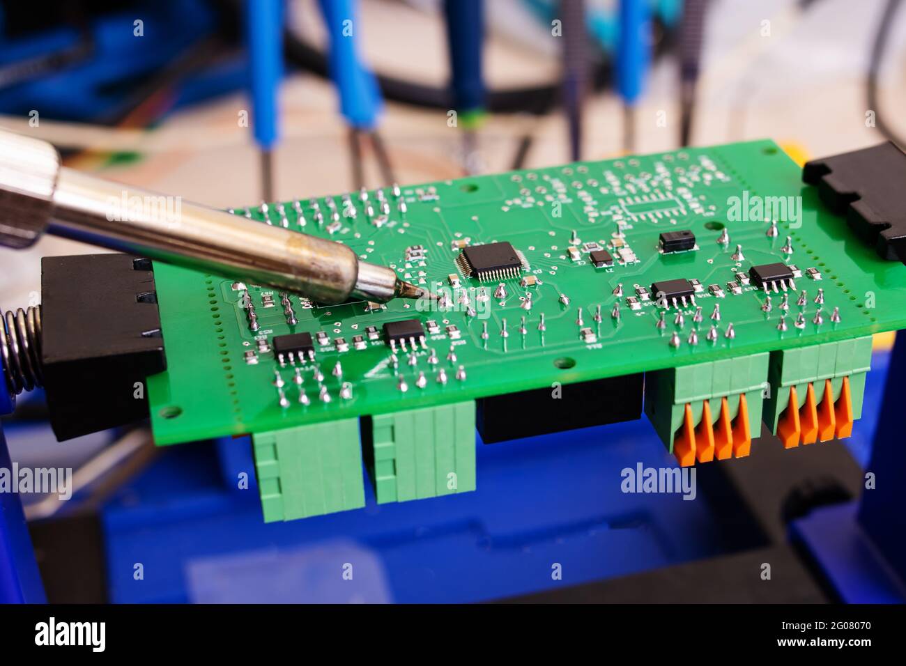 Soldering process on a green PCB close up Stock Photo - Alamy