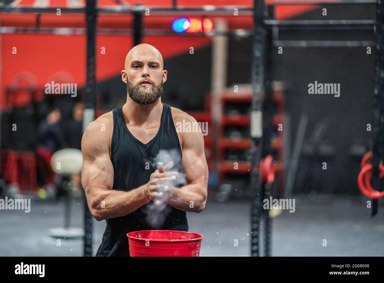 Muscular bearded guy in sportswear looking at camera clapping hands and ...