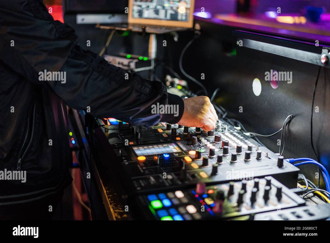 From above crop man playing professional two channel DJ controller ...