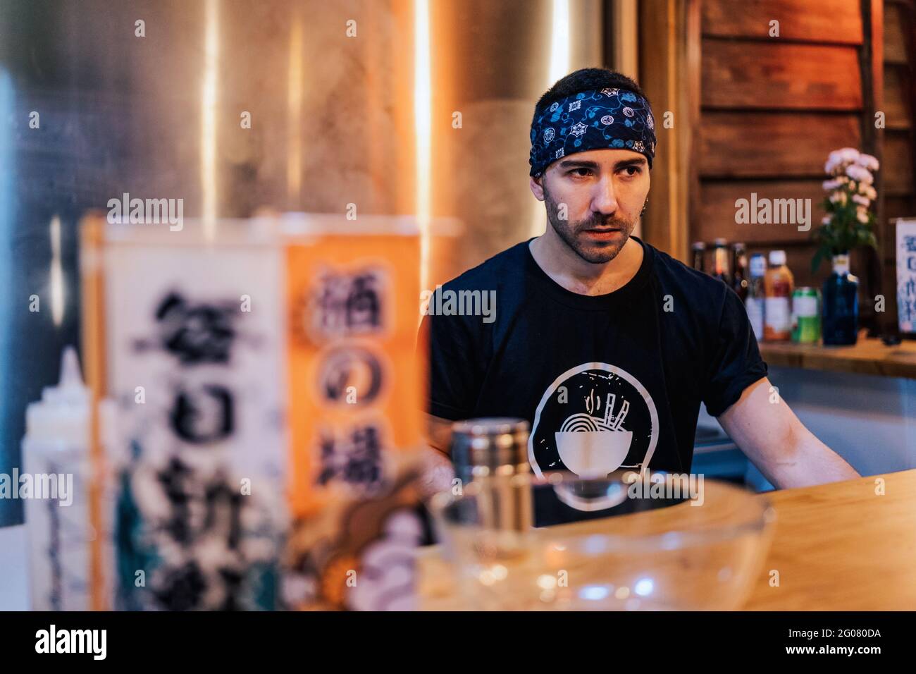 Wooden counter with glass empty bowl and colorful table tents with ...