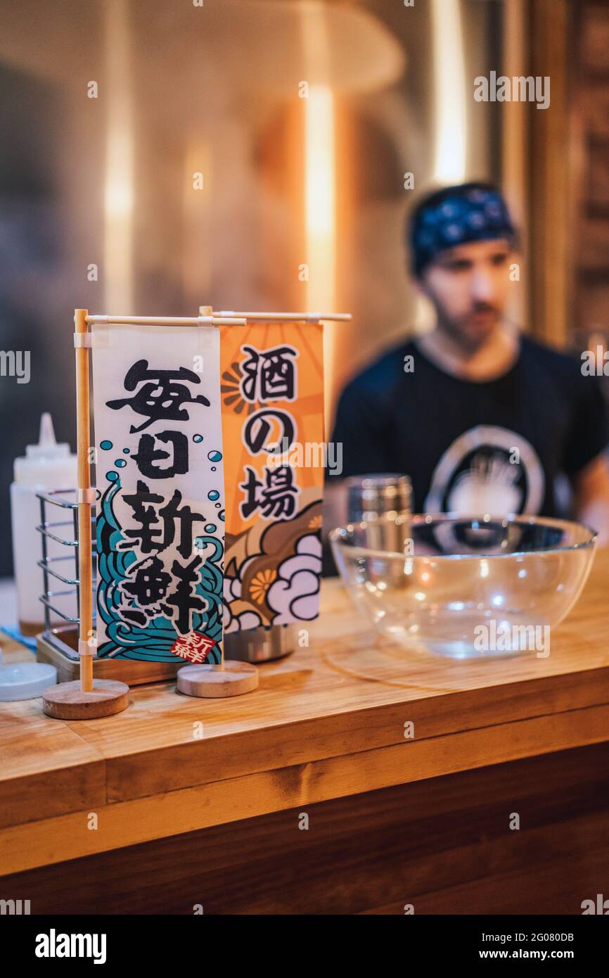 Wooden counter with glass empty bowl and colorful table tents with ...