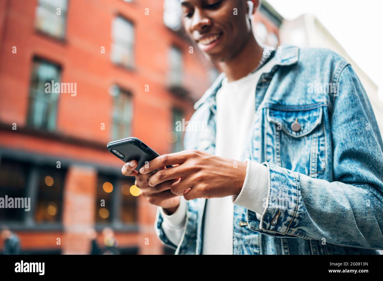 Full body of positive young African American female owner walking with ...