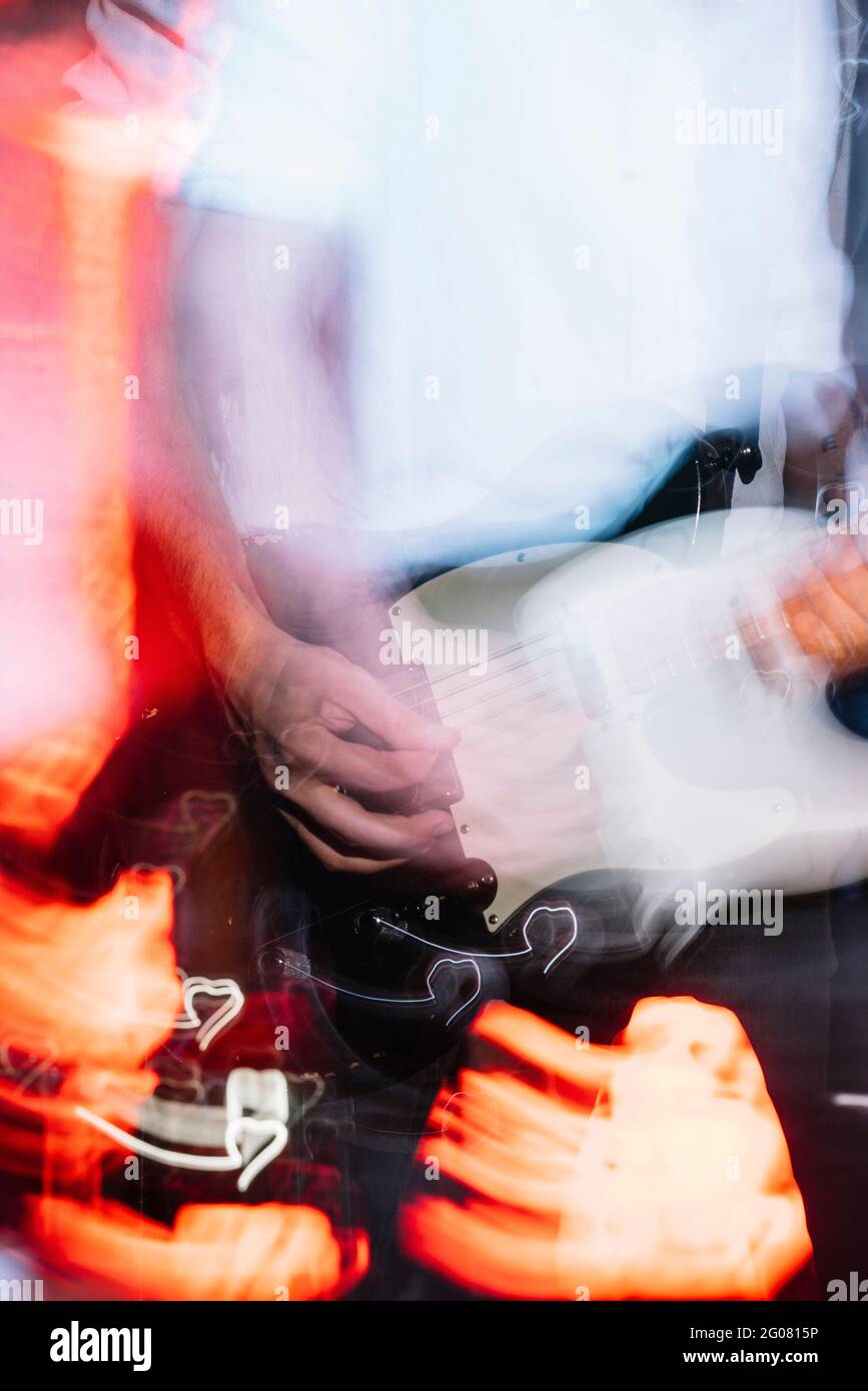 Blurred scene of guitar player playing an electric guitar con stage ...