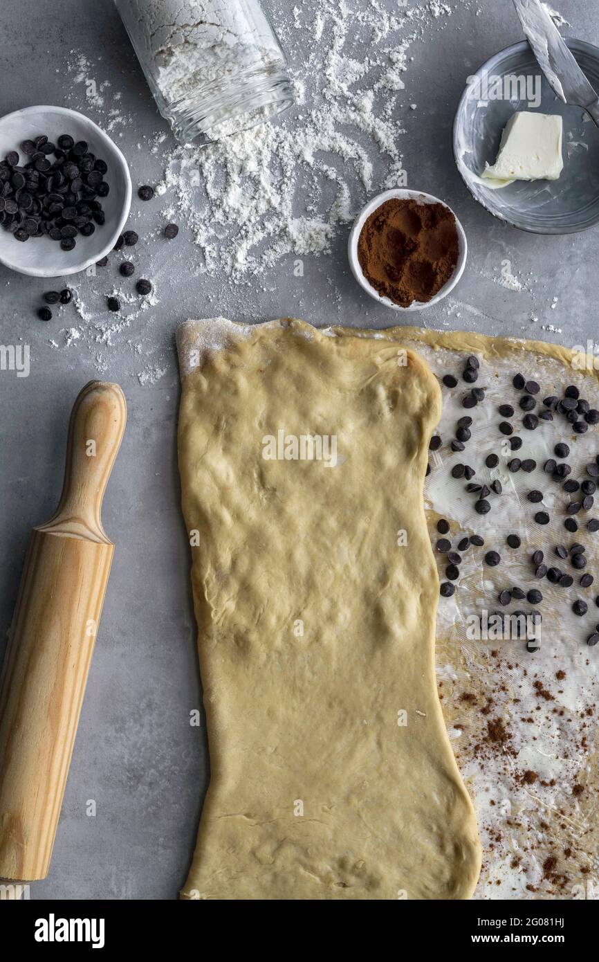 From above fresh dough for pastry covered in flour in concrete table ...