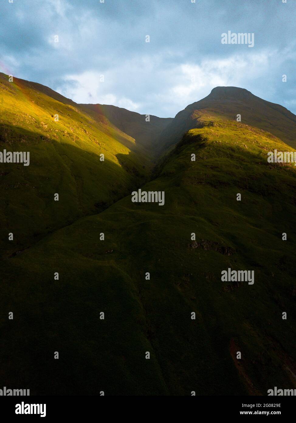 Overcast sundown sky over hill slope in peaceful evening in Glen Etive ...
