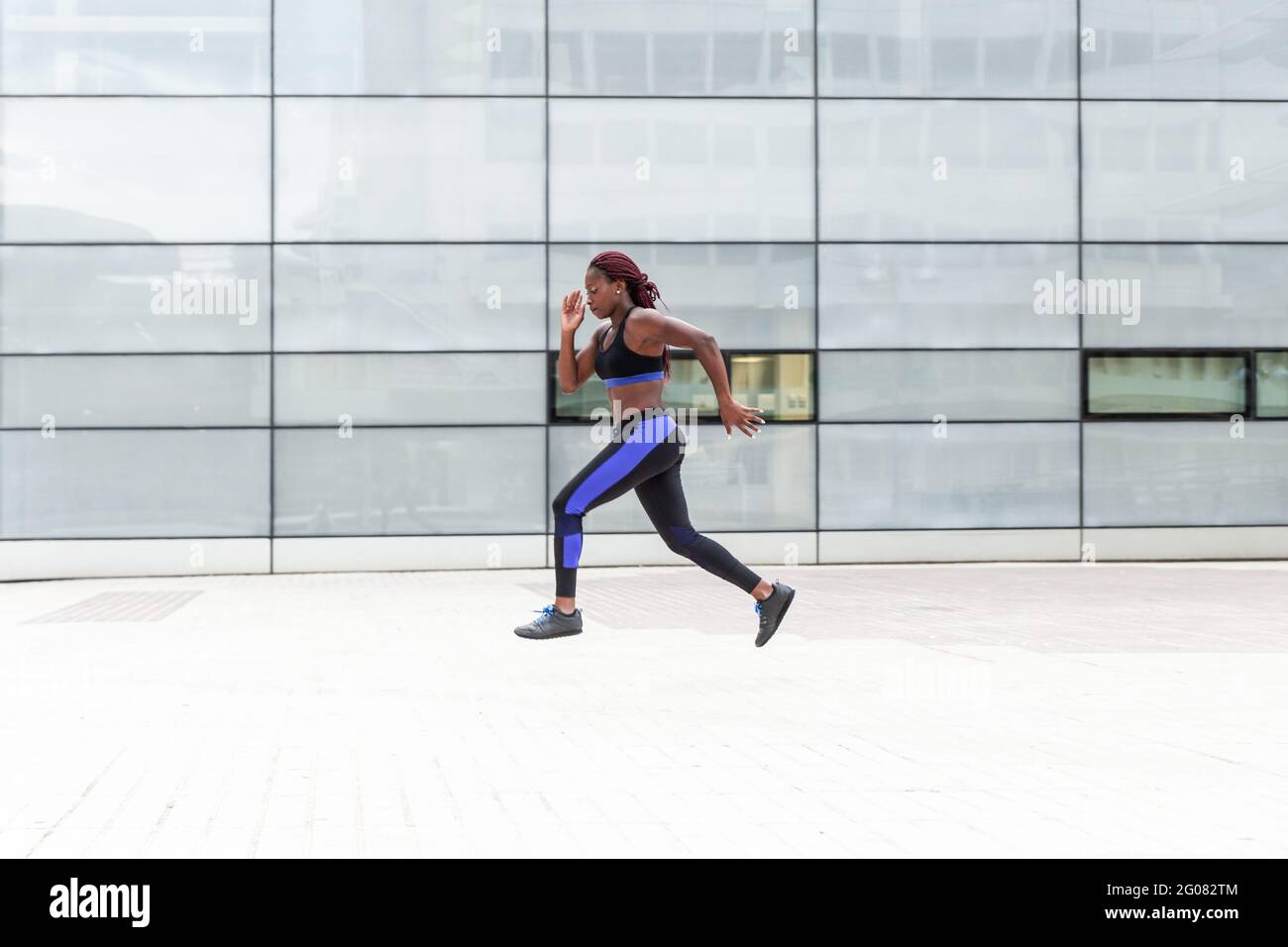 Woman african braids running hi-res stock photography and images - Alamy