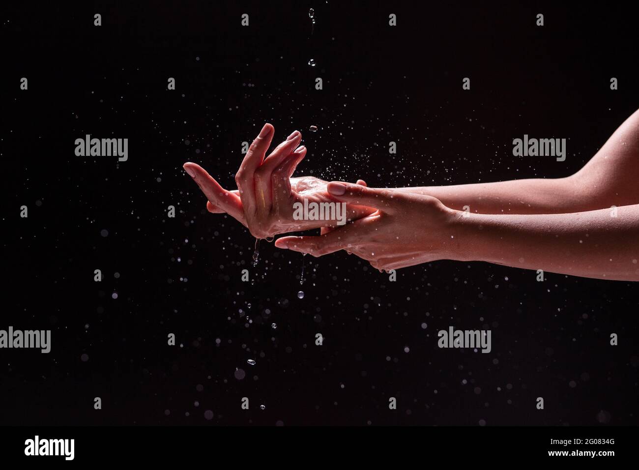 Crop view of anonymous Woman washing hands with splashing water against ...