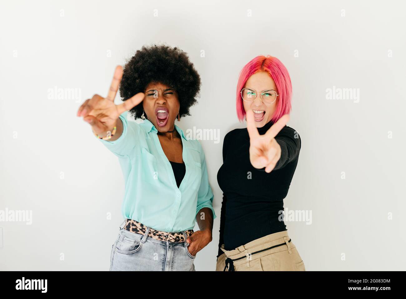 Modern trendy multiracial female friends in stylish outfit shouting ...