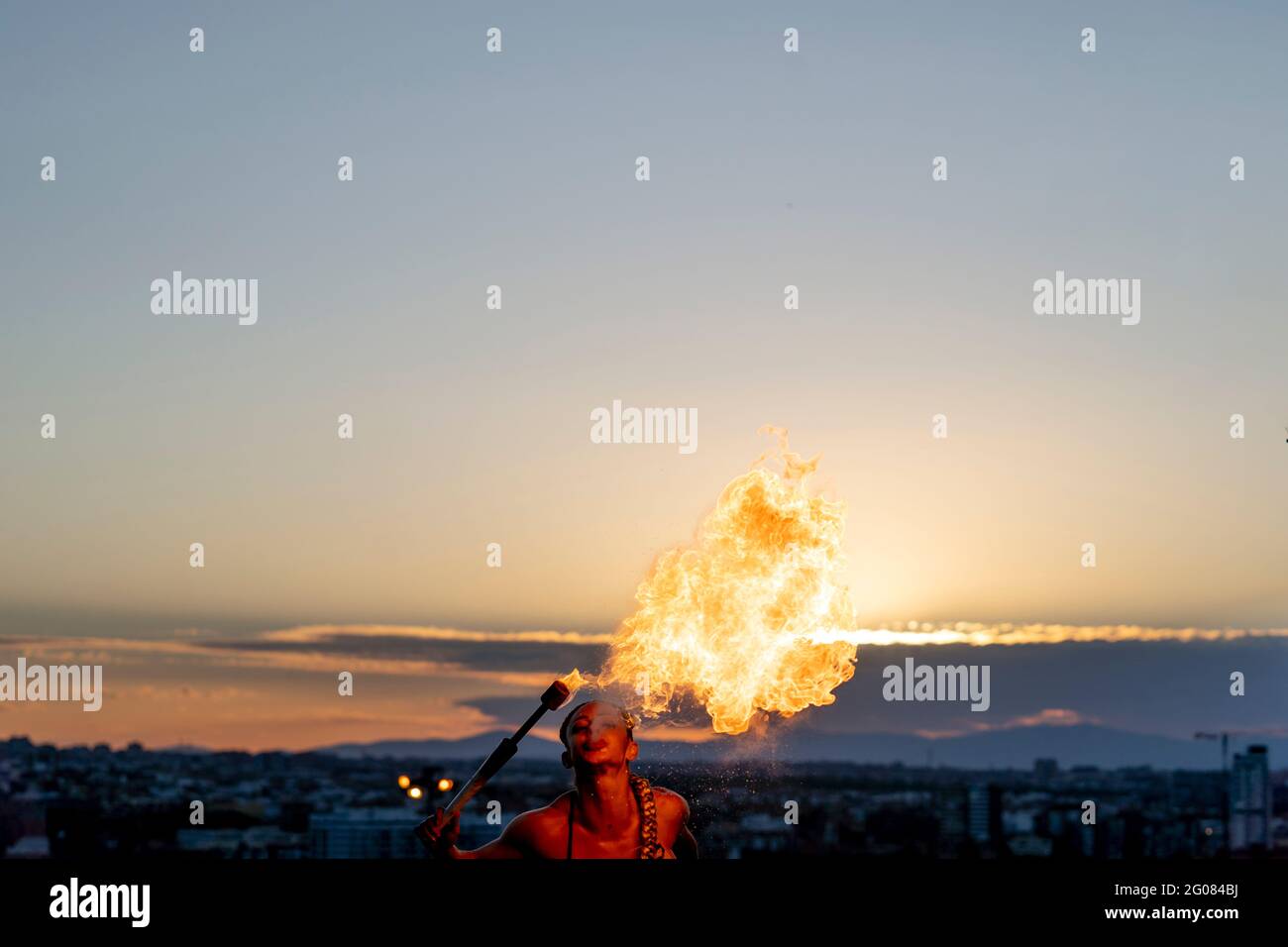 Fire-Eater Woman Performing Spit Fire At Sunset Stock Photo - Alamy