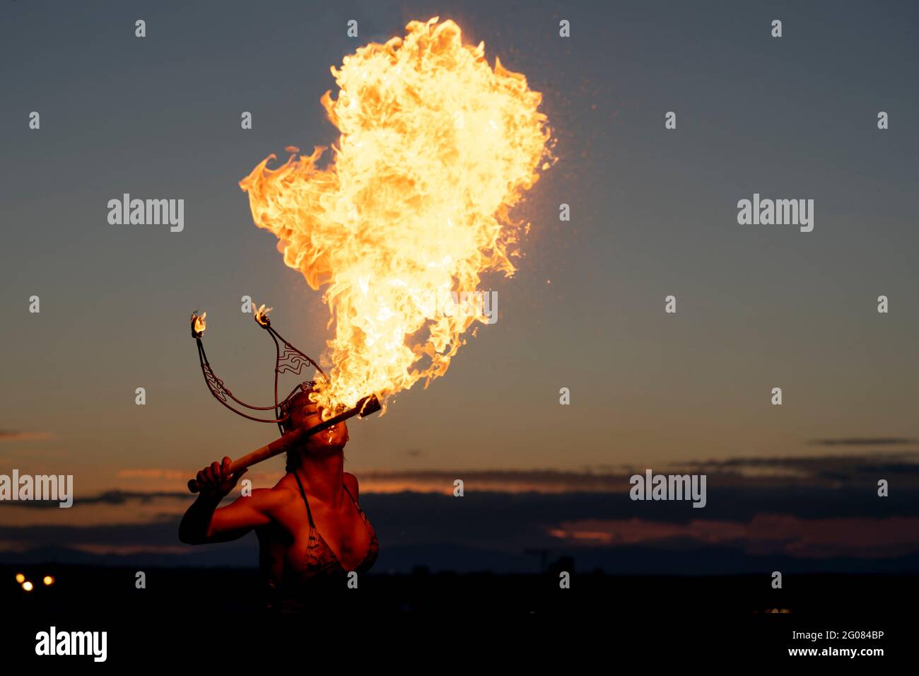 Fire-Eater Woman Performing Spit Fire At Sunset Stock Photo - Alamy