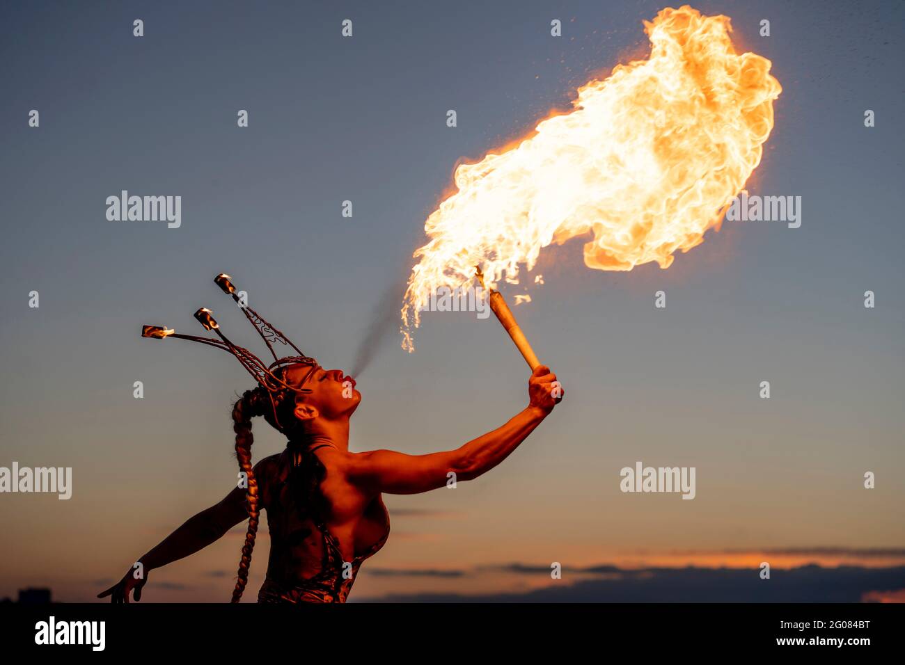 Fire-Eater Woman Performing Spit Fire At Sunset Stock Photo - Alamy