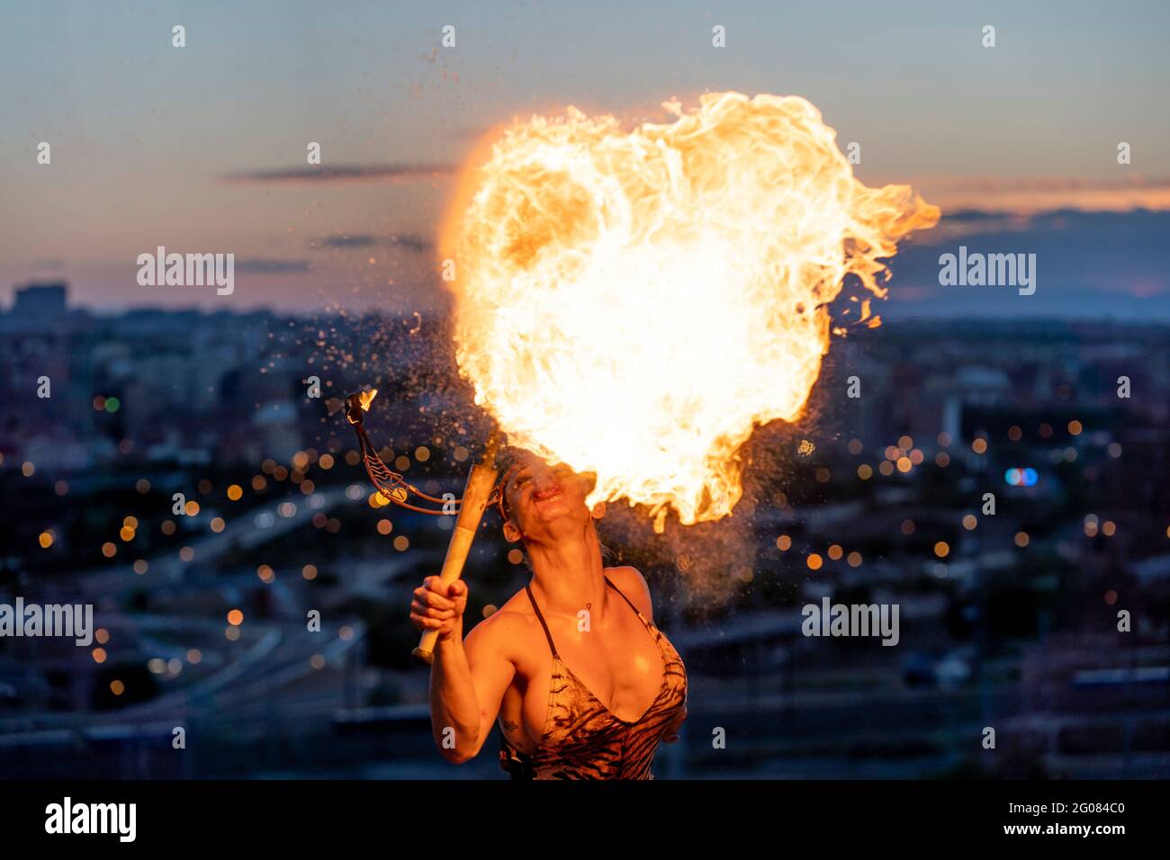 Fire-Eater Woman Performing Spit Fire At Sunset Stock Photo - Alamy