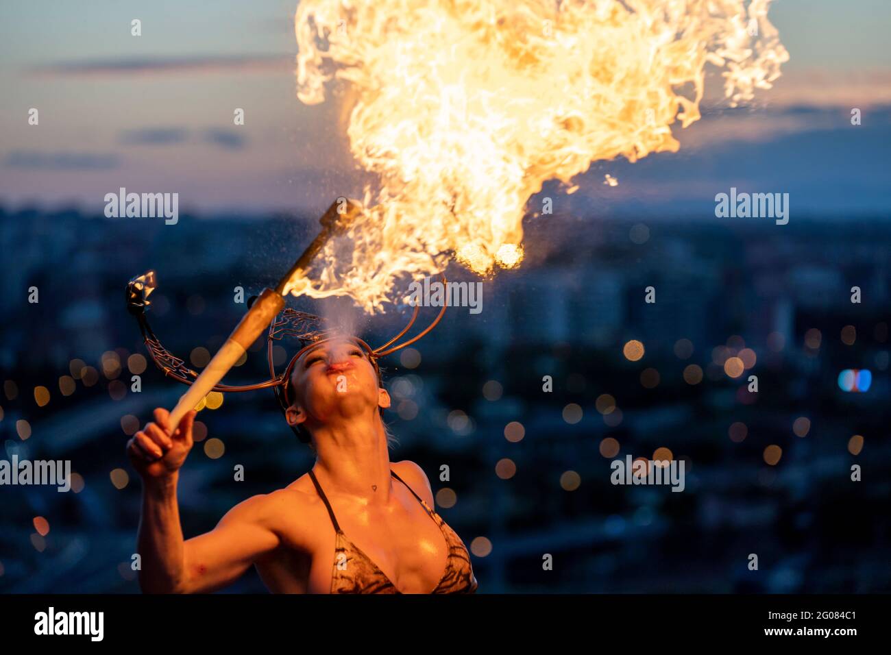 Fire-Eater Woman Performing Spit Fire At Sunset Stock Photo - Alamy