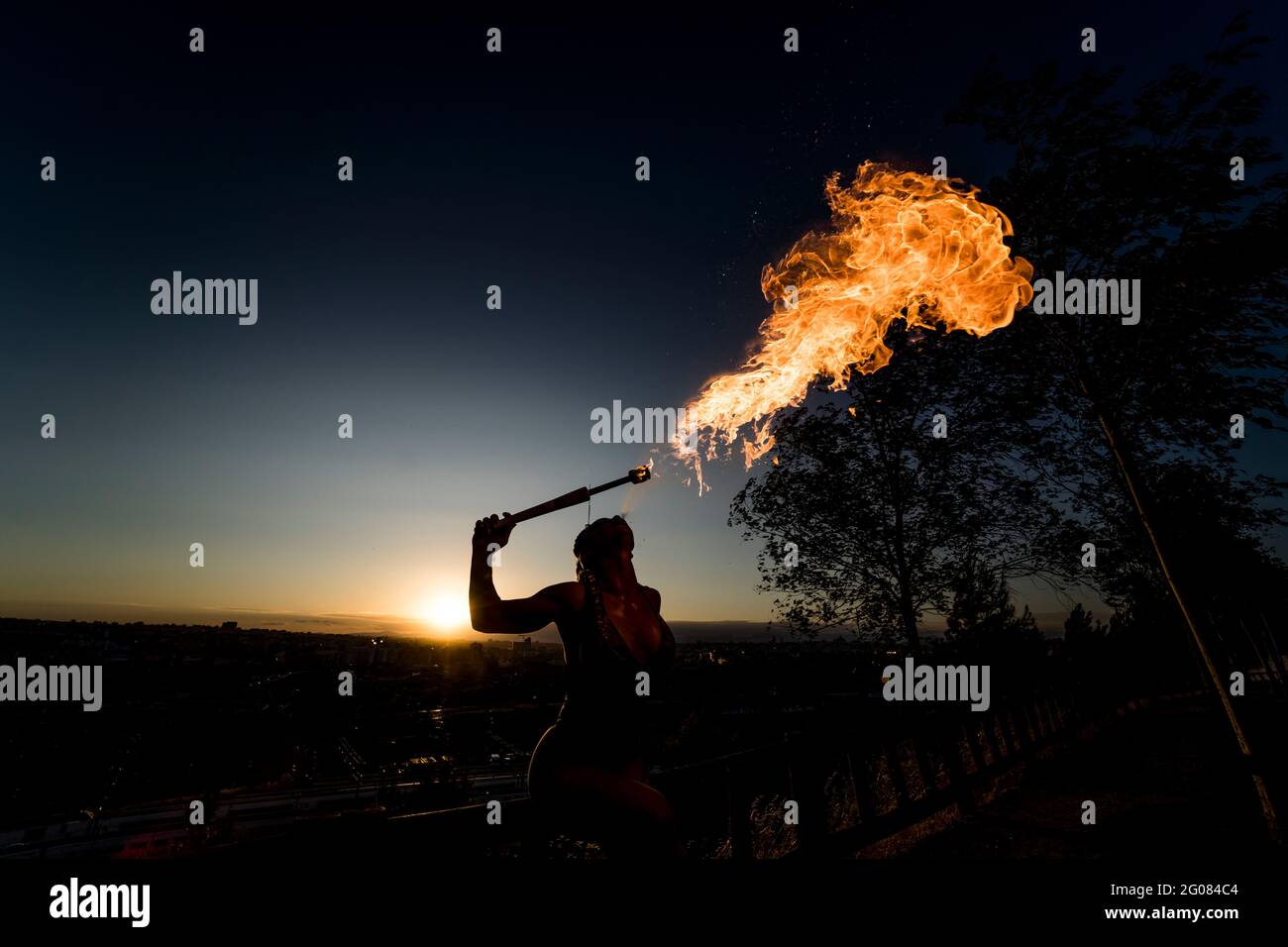 Fire-Eater Woman Performing Spit Fire At Sunset Stock Photo - Alamy