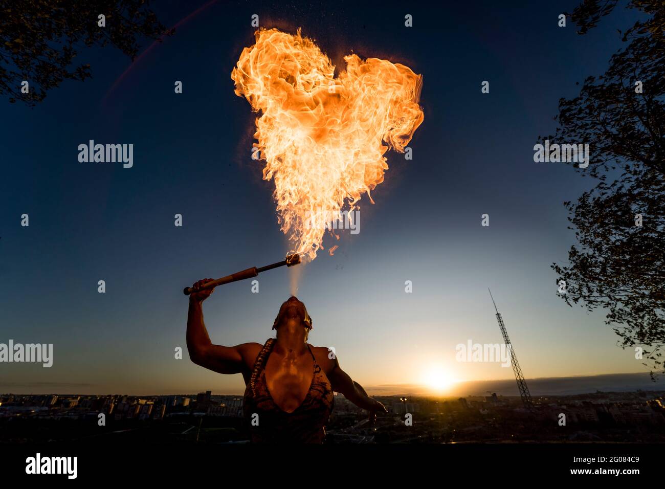 Fire-Eater Woman Performing Spit Fire At Sunset Stock Photo - Alamy