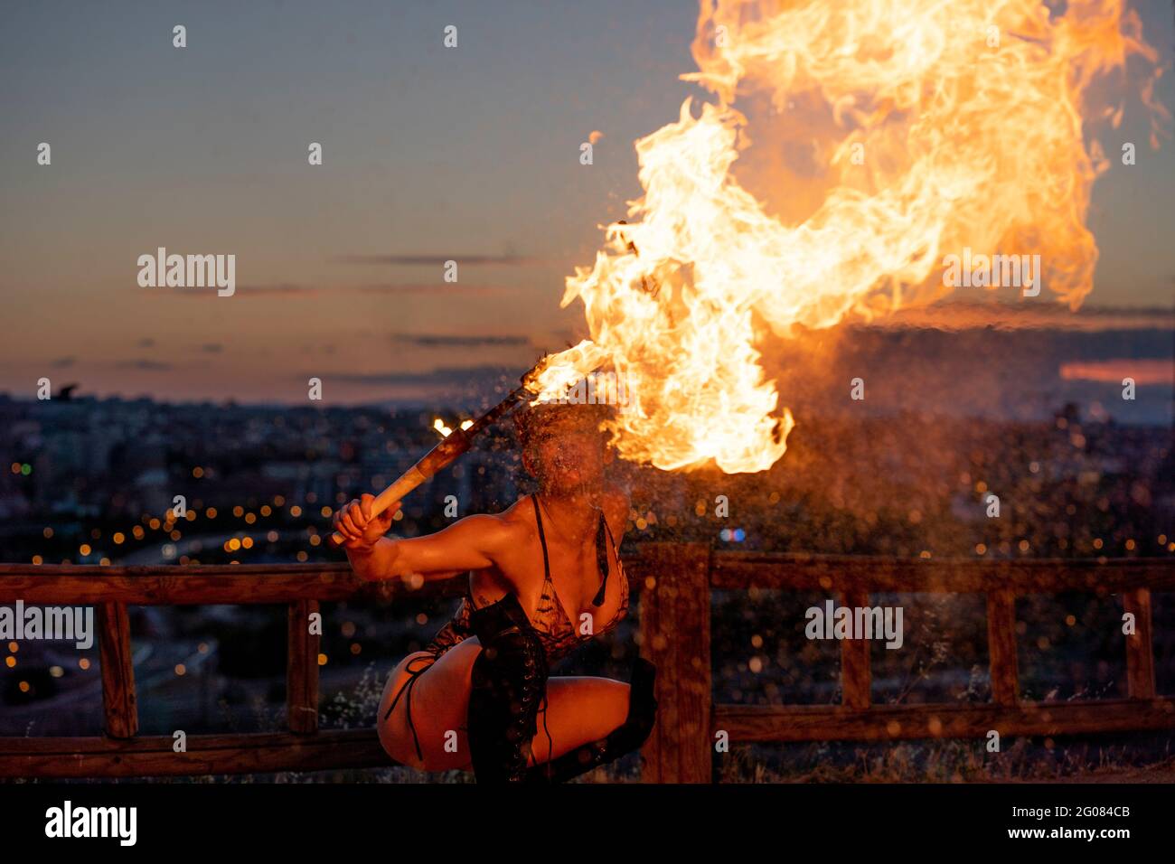 Fire-Eater Woman Performing Spit Fire At Sunset Stock Photo - Alamy