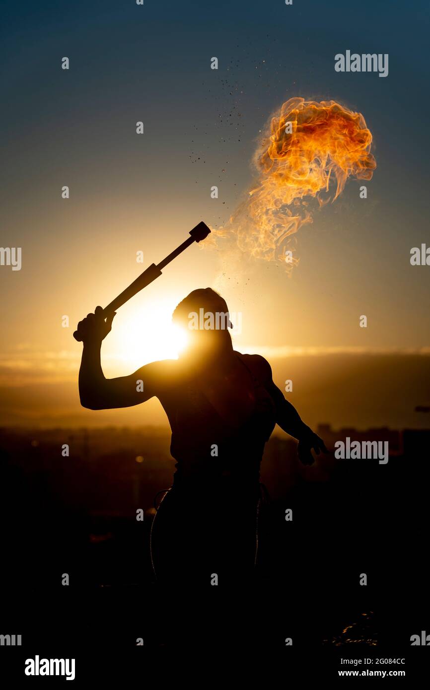 Fire-Eater Woman Performing Spit Fire At Sunset Stock Photo - Alamy