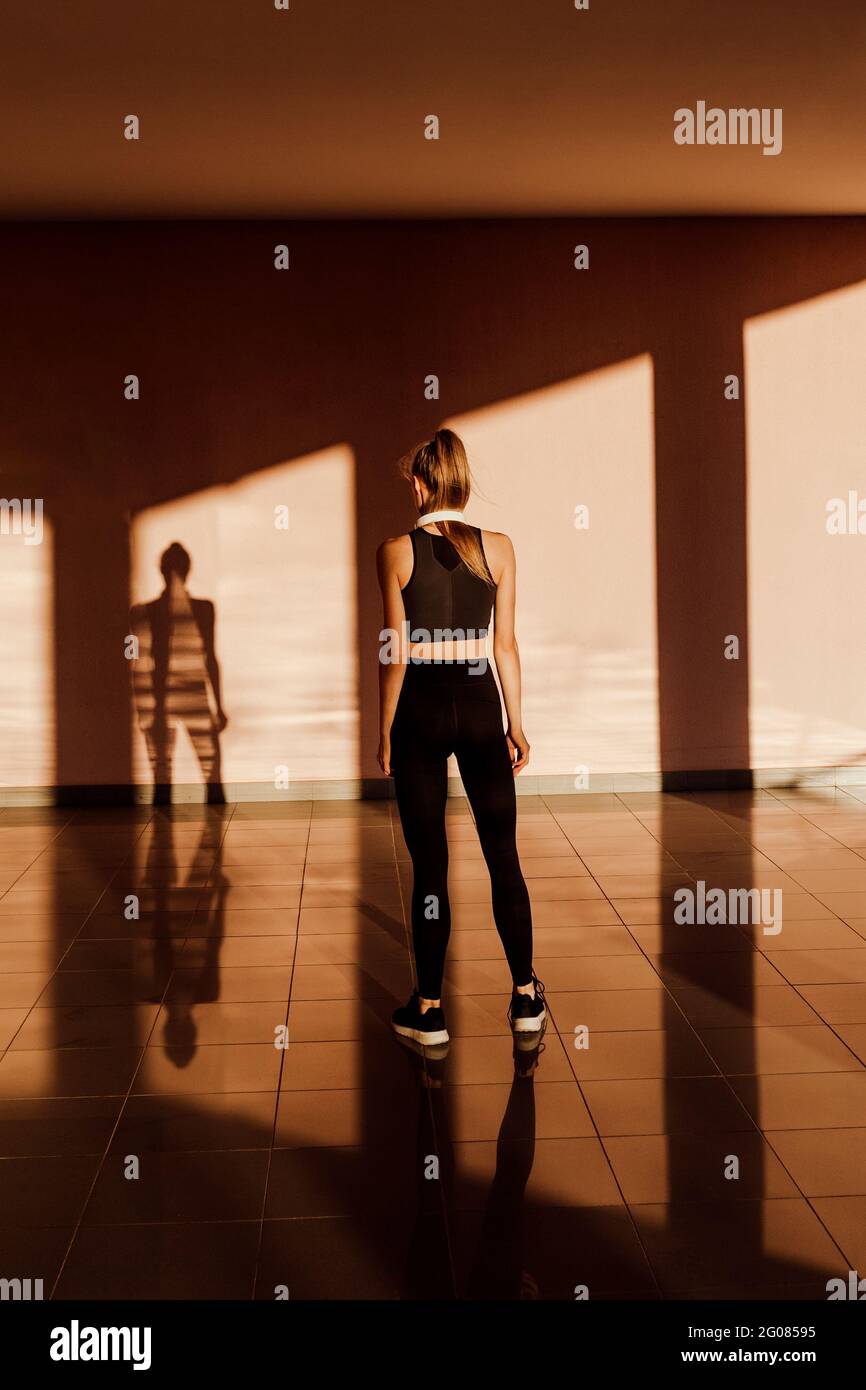 Back view of standing anonymous young athletic caucasian Woman at ...