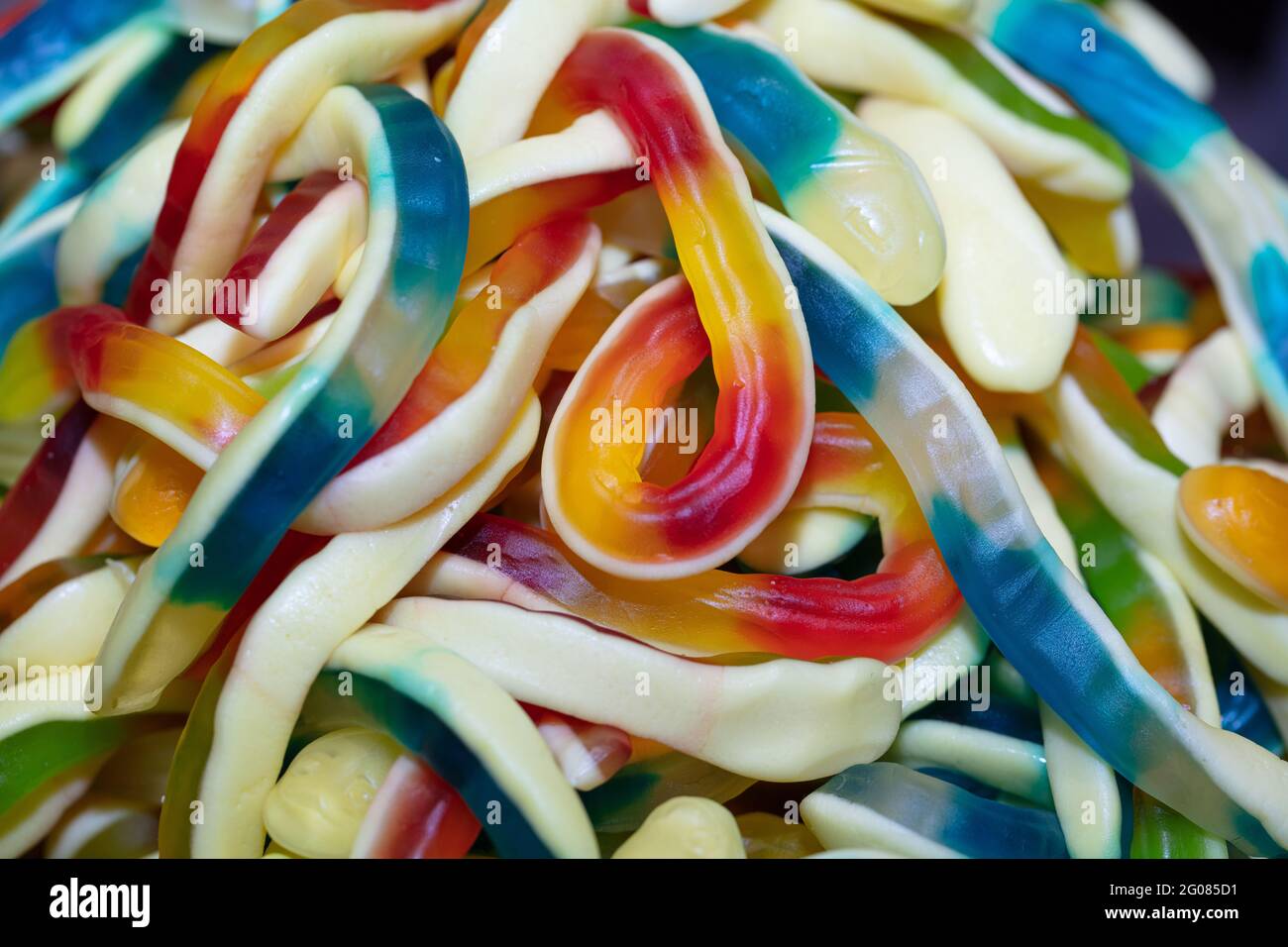 Multicolored jelly worm candies textured background Stock Photo - Alamy