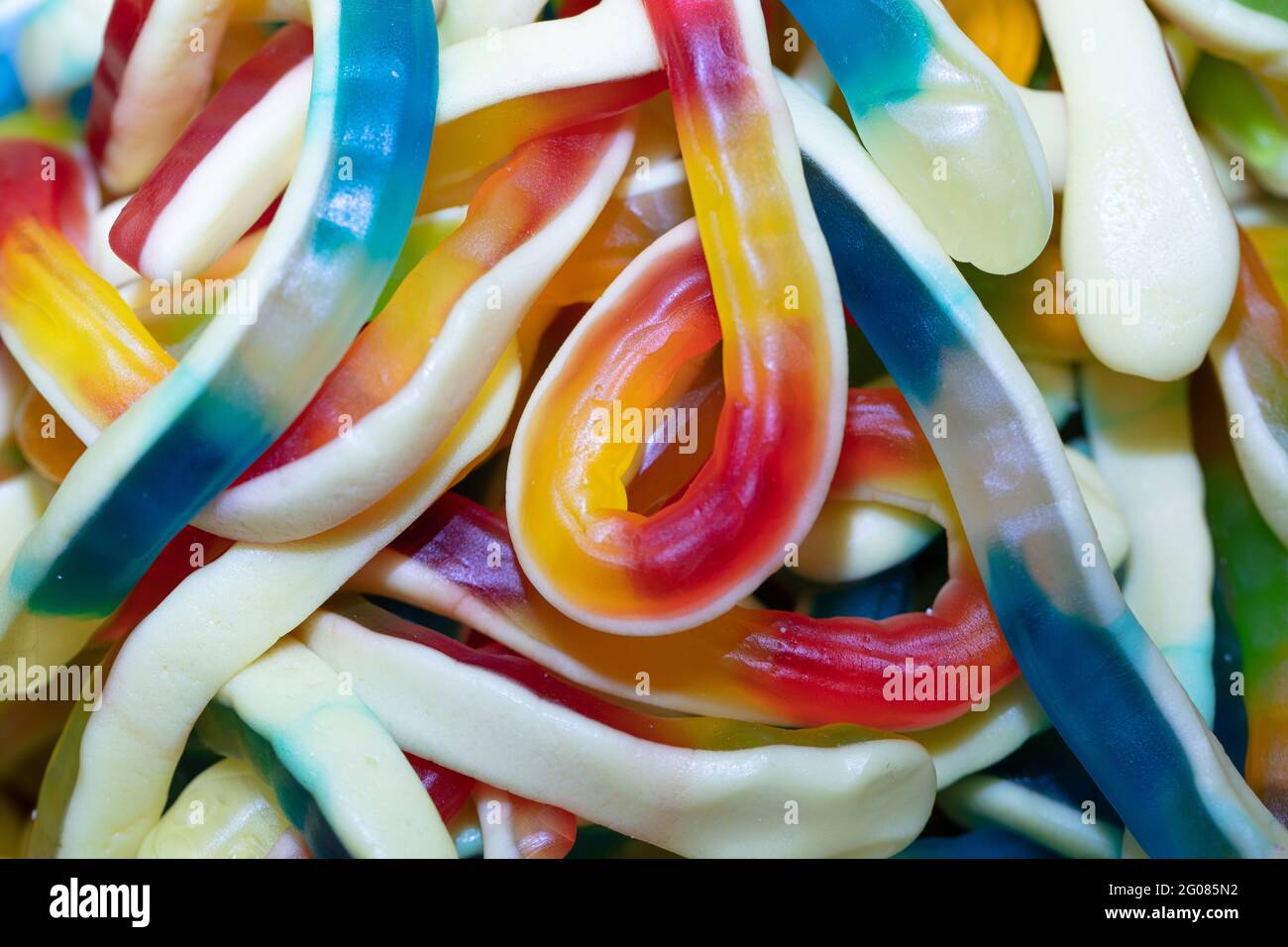 Multicolored jelly worm candies textured background Stock Photo - Alamy
