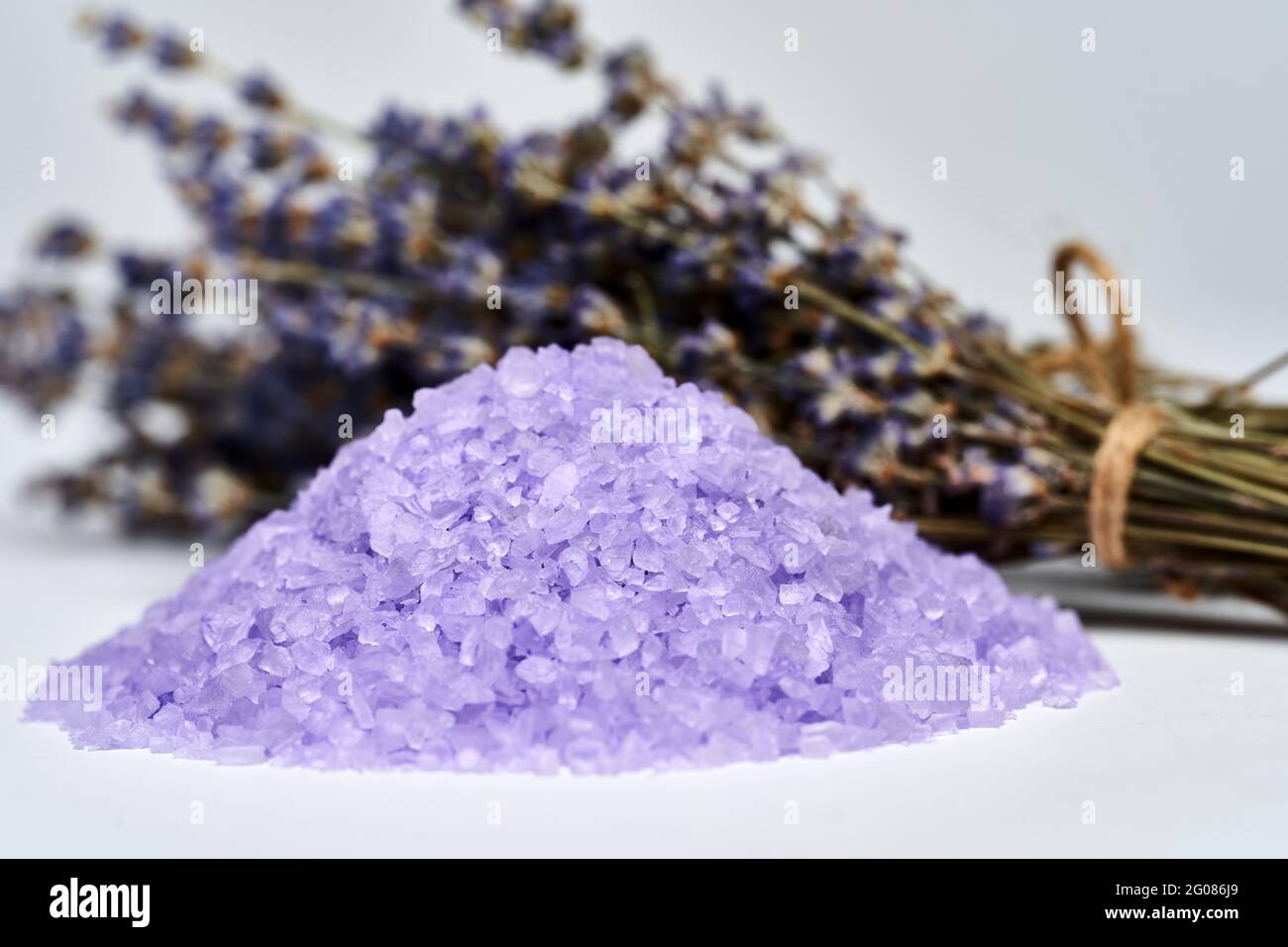 Closeup of a pile of lavender bath salt isolated on white background ...
