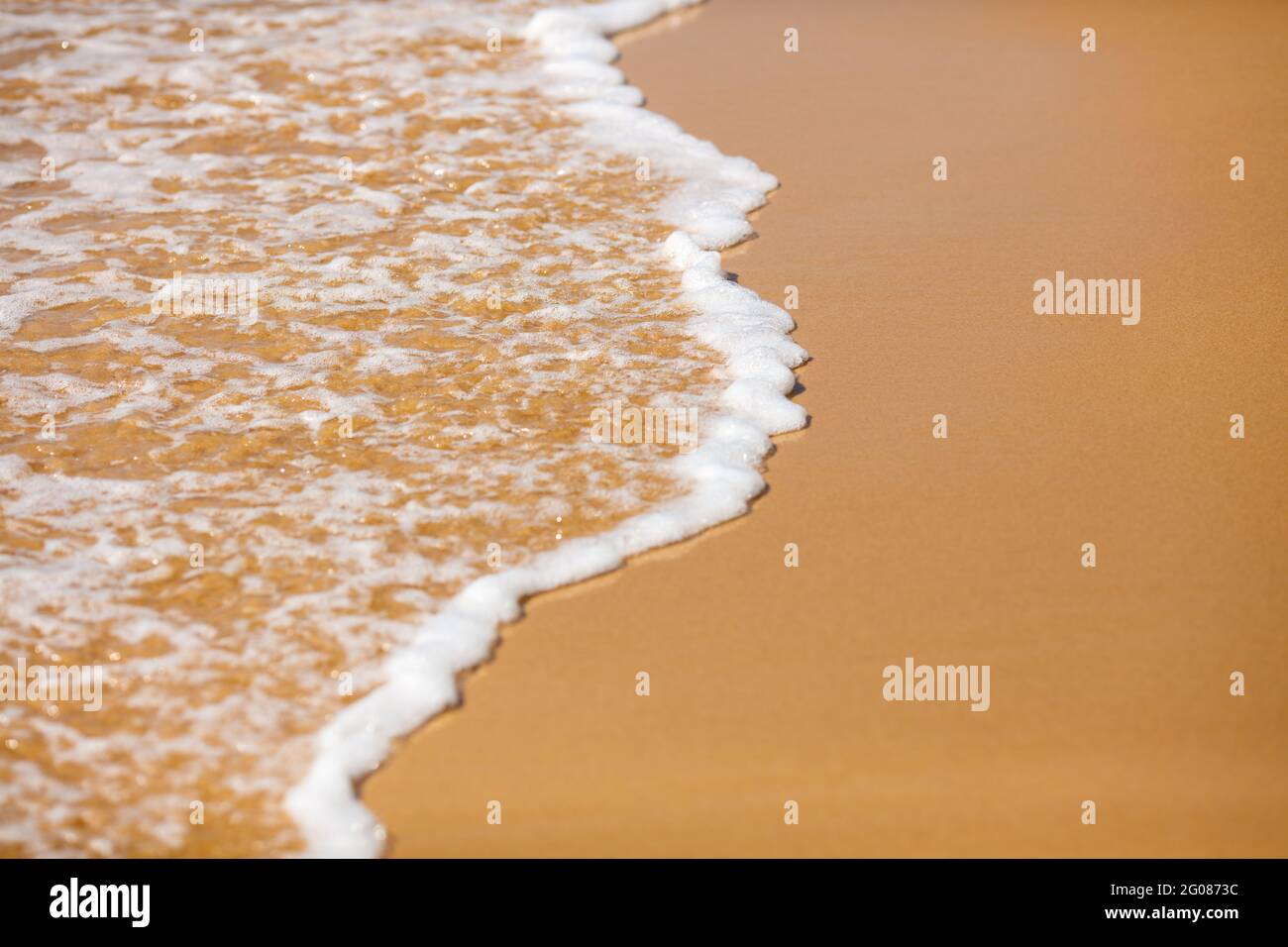 Summer background of sandy beach with water edge Stock Photo - Alamy