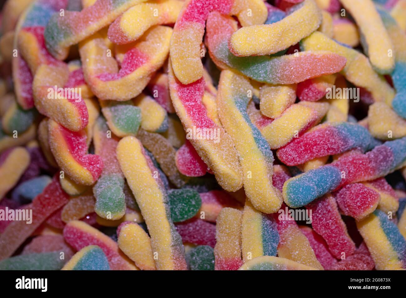 Multicolored jelly worm candies textured background Stock Photo - Alamy