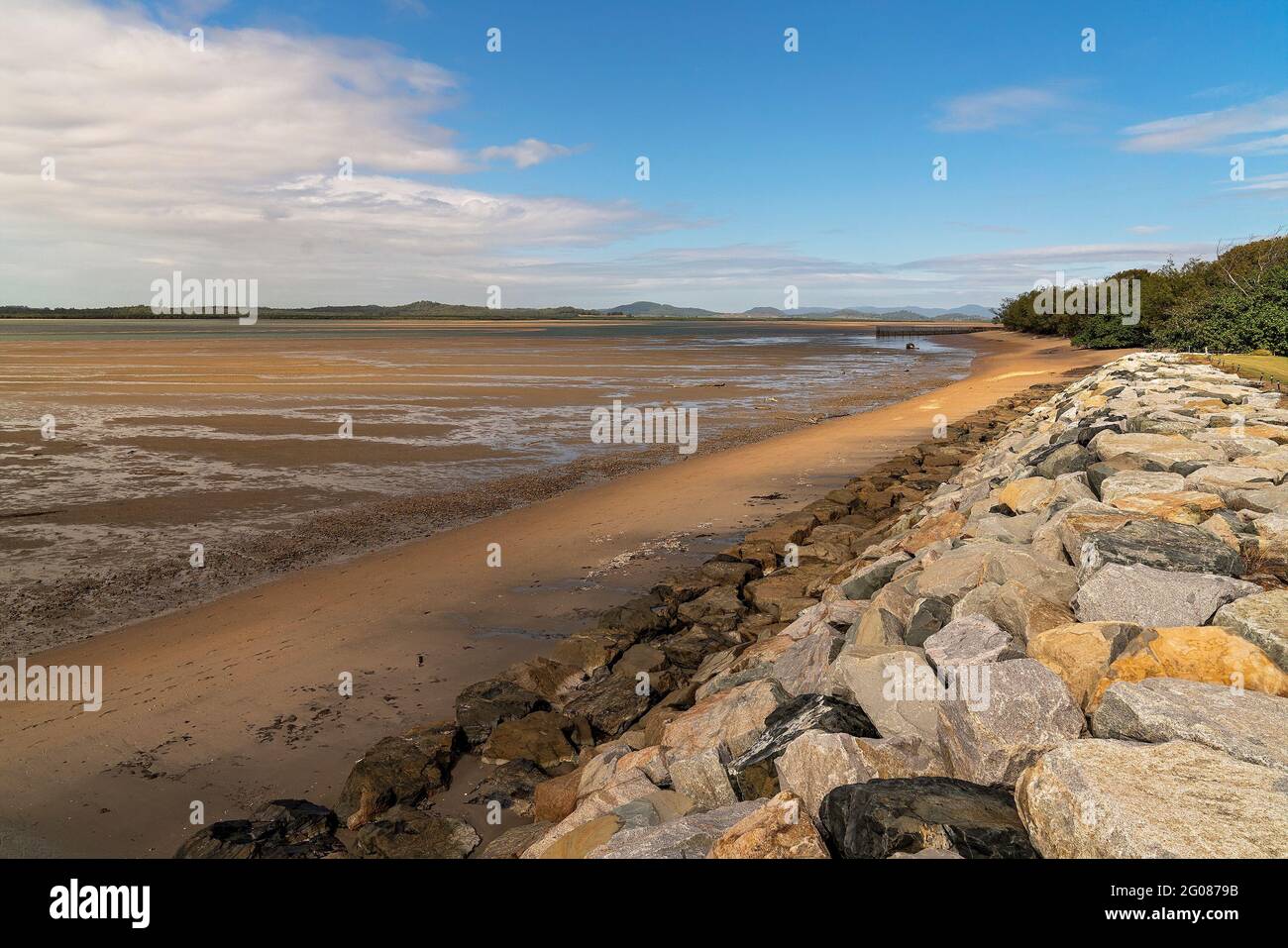 A rock sea wall built to protection the beach from erosion Stock Photo ...