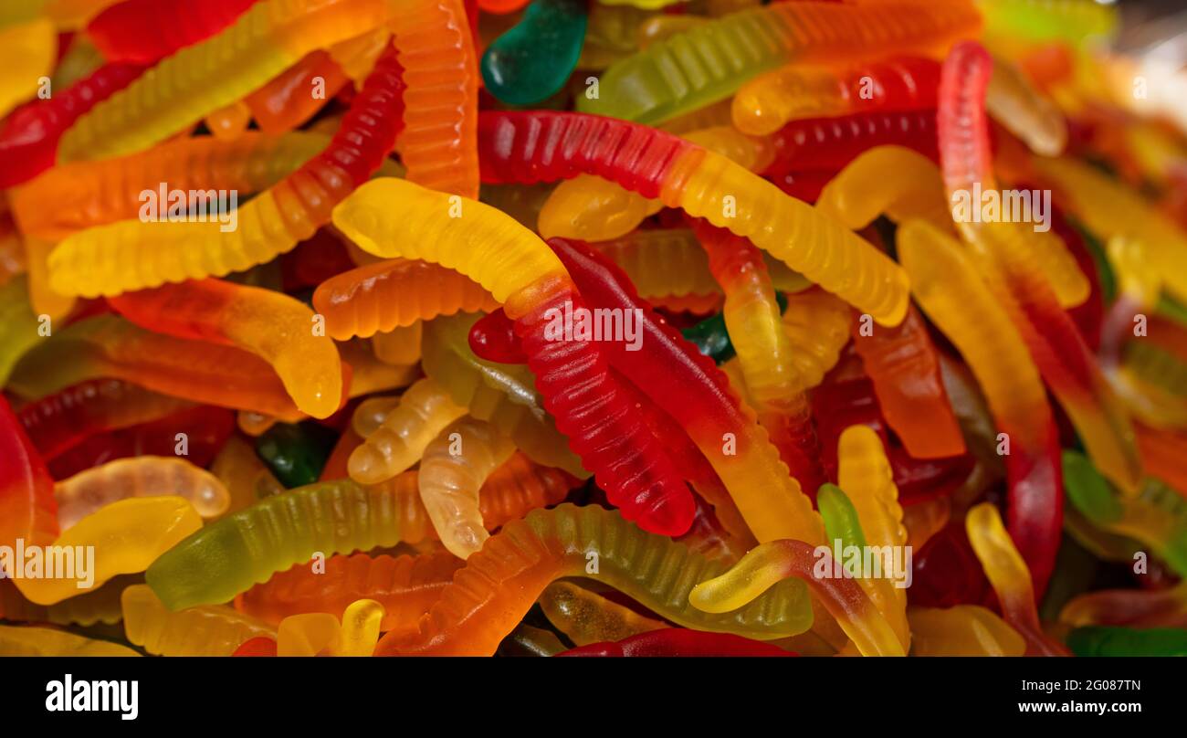 Multicolored jelly worm candies textured background Stock Photo - Alamy