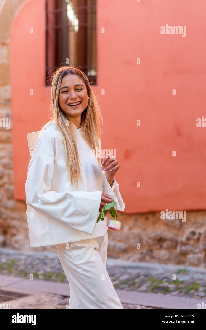 Vertical shot of a smiling Caucasian blonde female holdina flower Stock ...