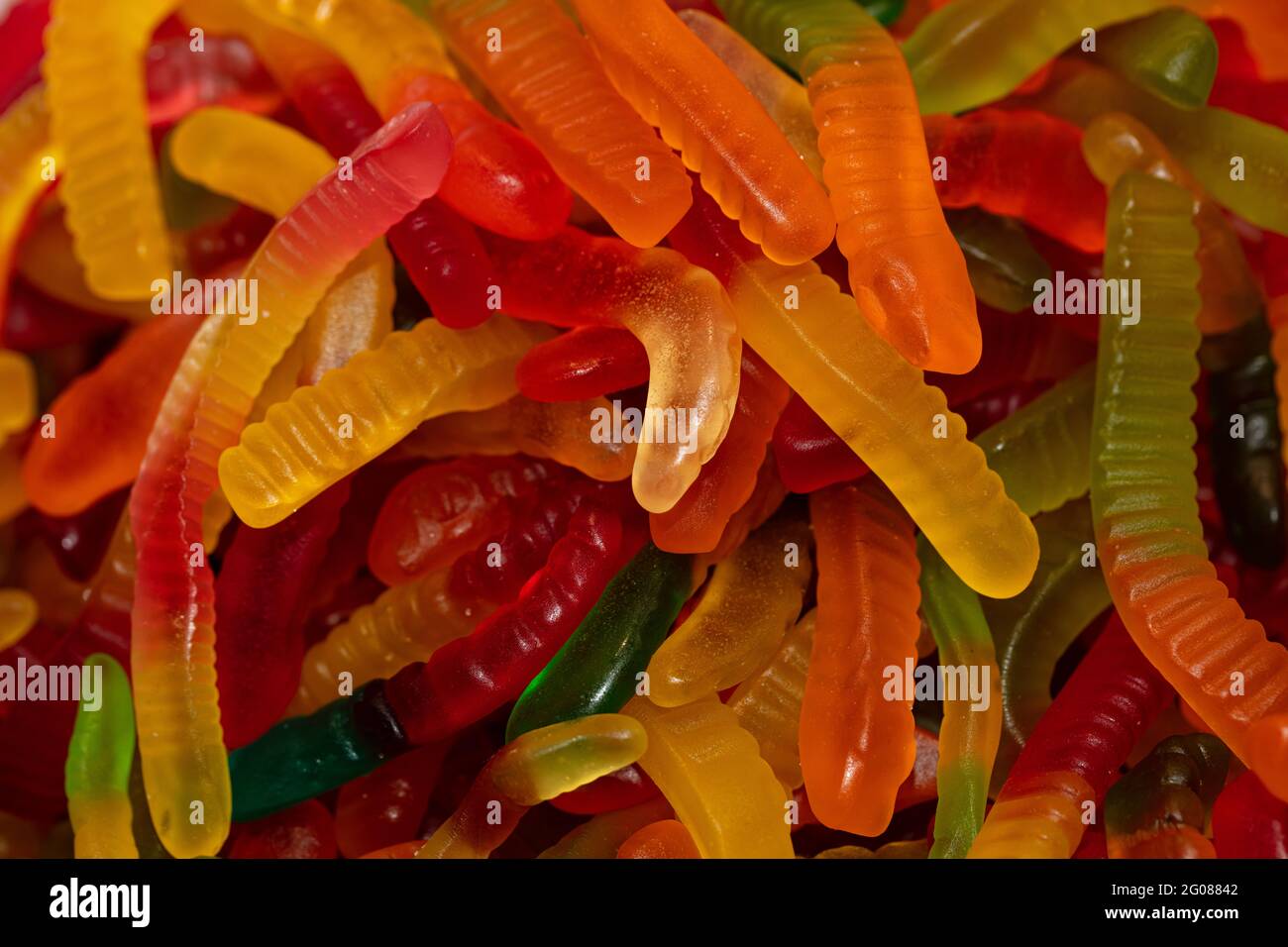 Multicolored jelly worm candies textured background Stock Photo - Alamy