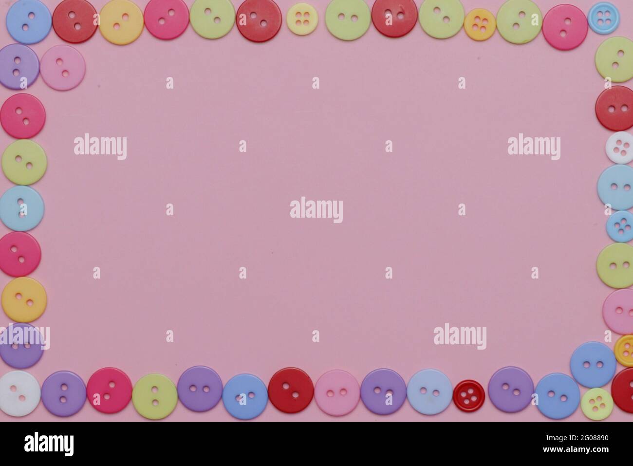 Closeup shot of colorful plastic buttons on the pink background ...