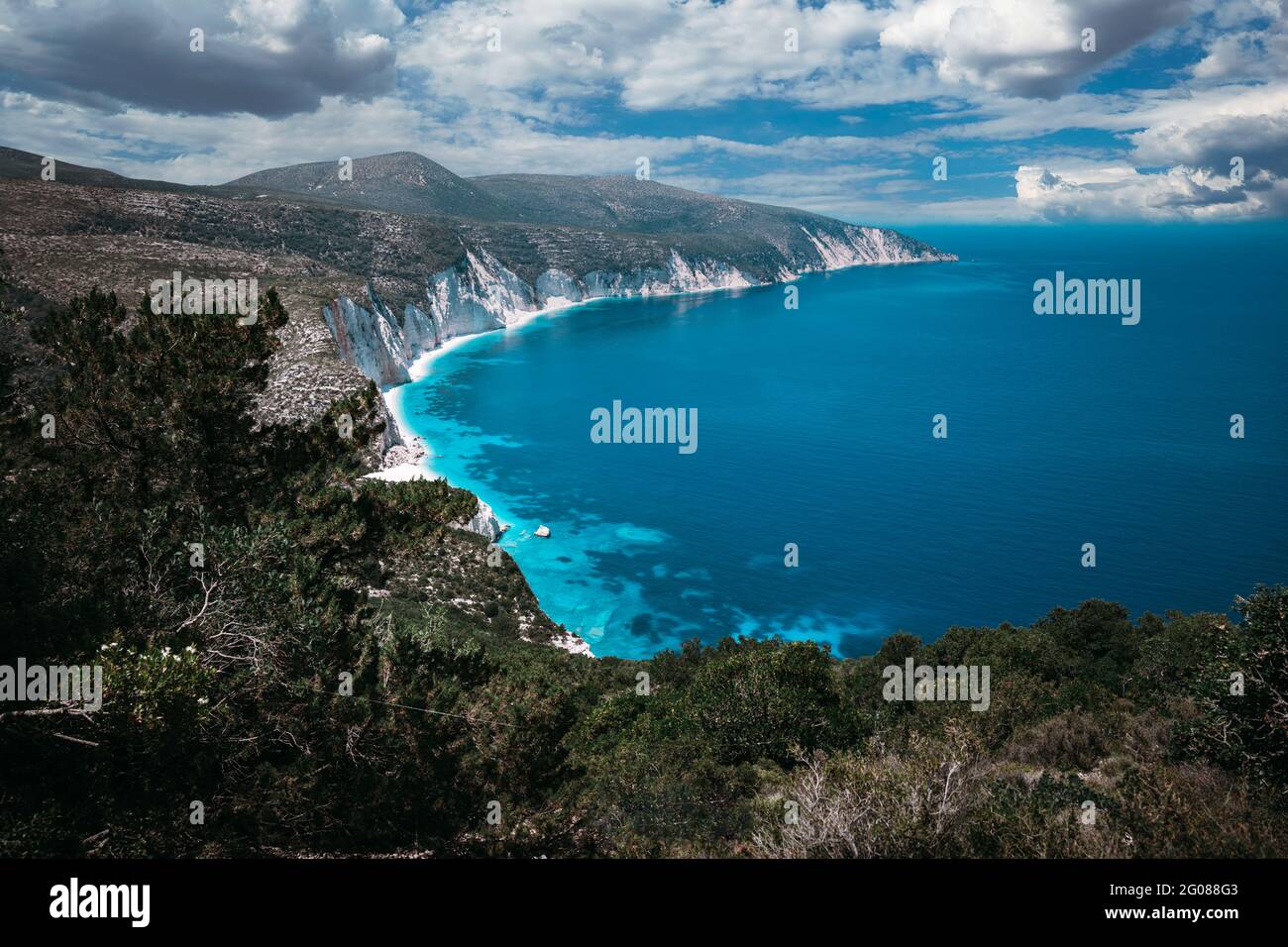 Fteri beach. Blue lagoon with rocky coastline, Kefalonia, Greece. Calm ...