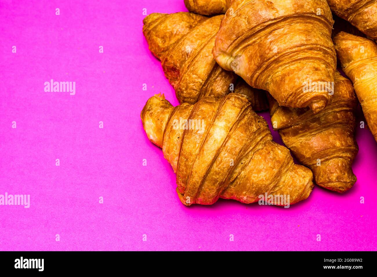 Top view of newly baked croissants isolated on a purple background ...
