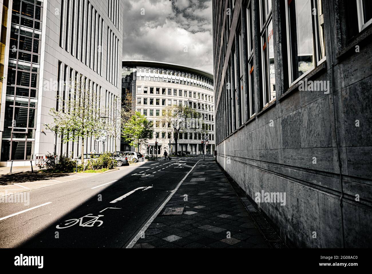 Road surrounded by modern residential buildings under a cloudy sky in ...