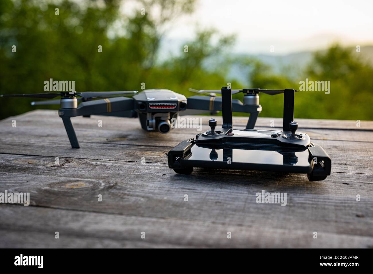 DJI Mavic pro drone with a mobile phone plugged to a controller on a ...