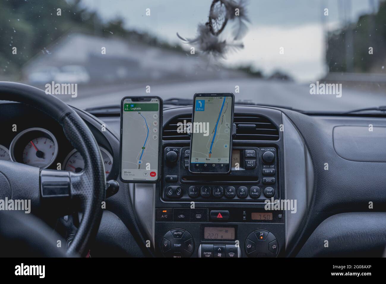 Car interior with the phones used as navigation devices Stock Photo - Alamy