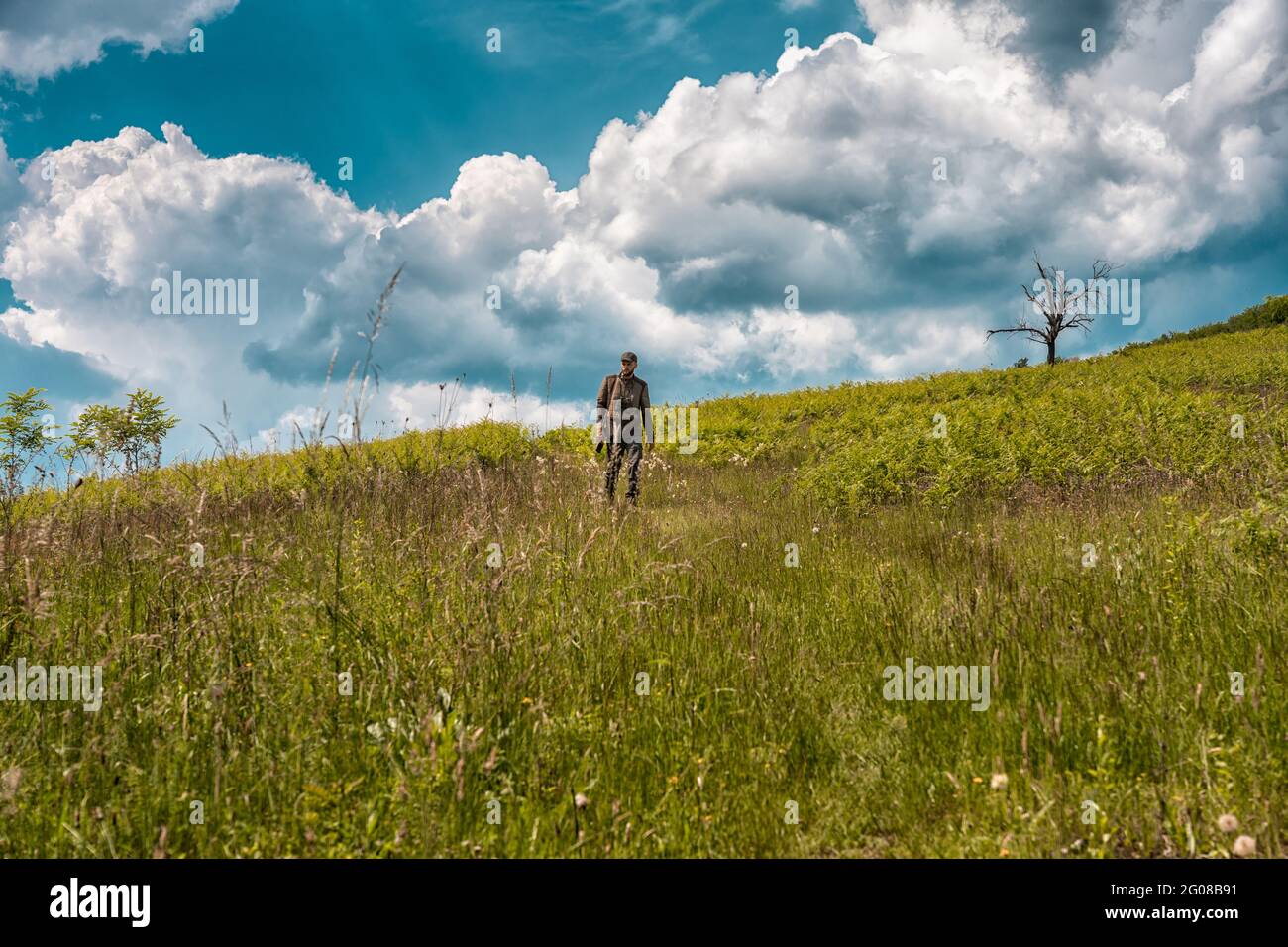 Young hunter climbing a hill in search for prey with beautiful ...