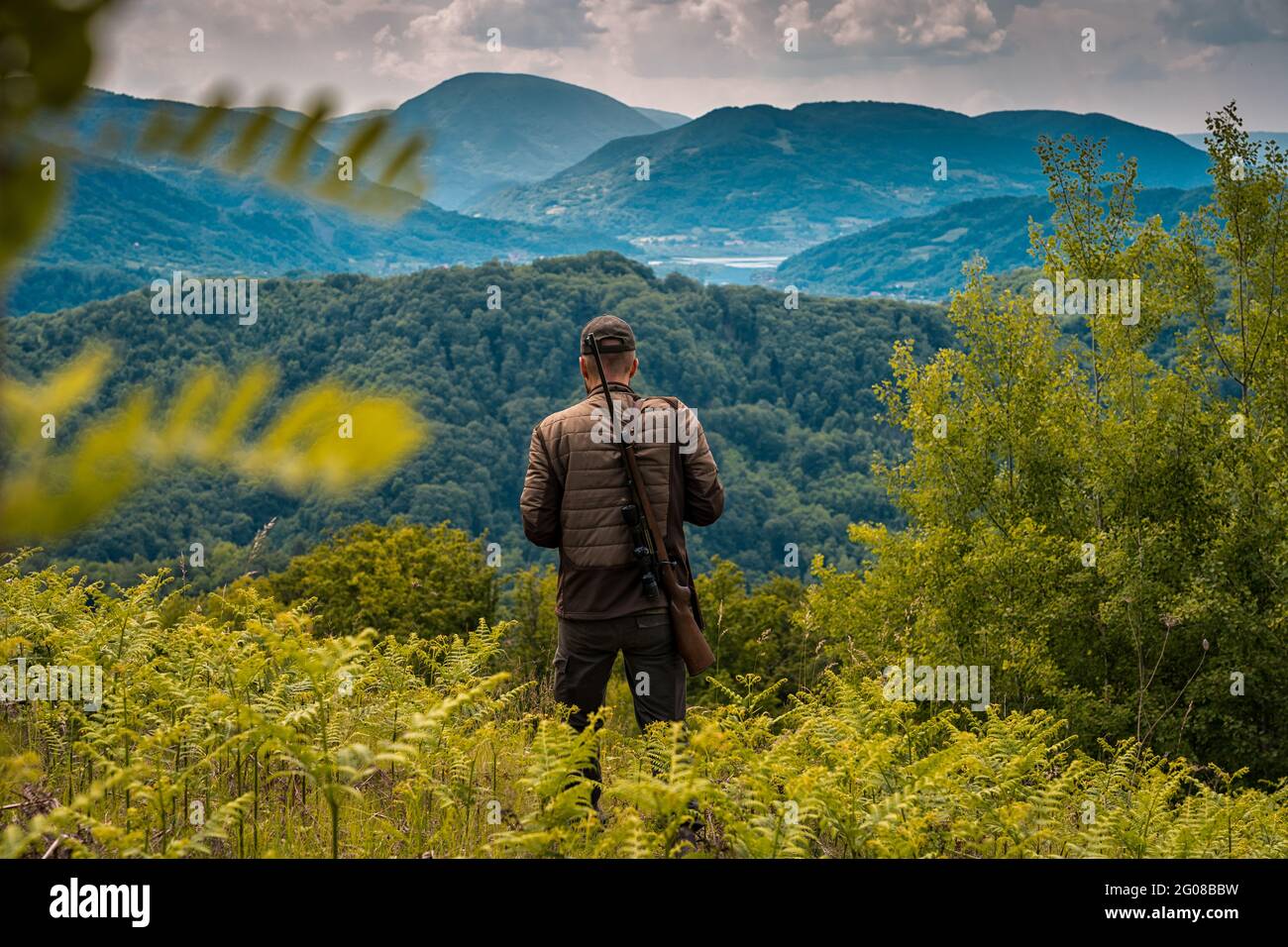 Hunter checking for prey high up in the mountains Stock Photo - Alamy