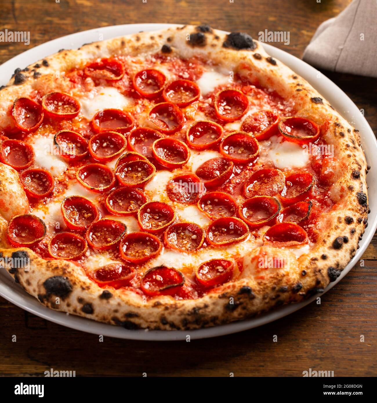 Freshly baked Neapolitan pizza with pepperoni and mozzarella Stock ...