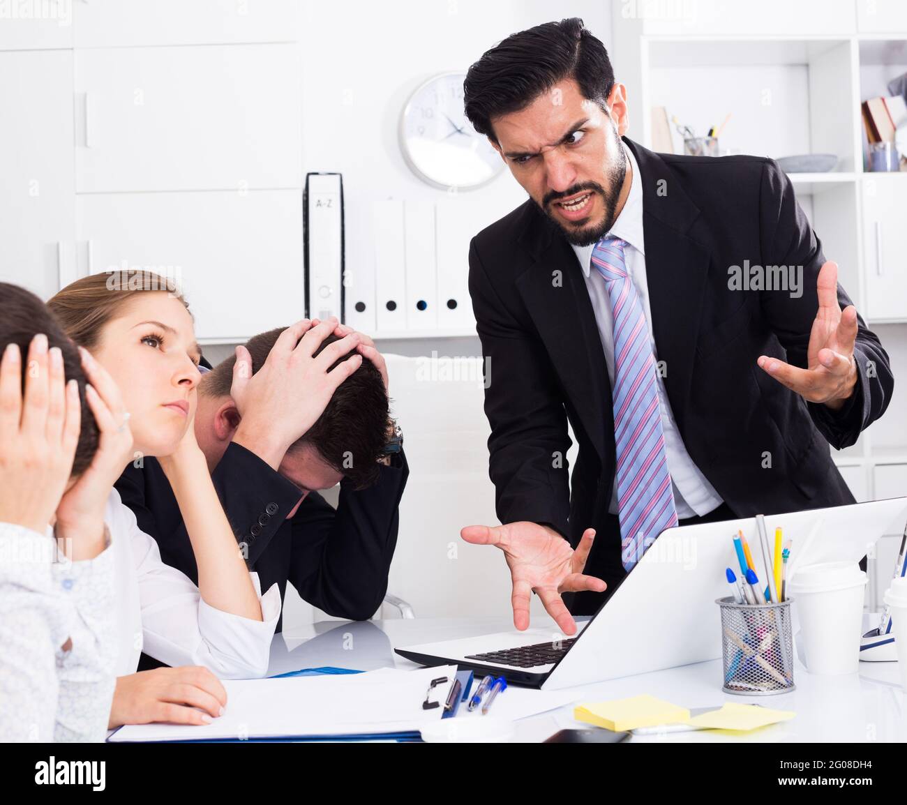 Businessman feeling angry to coworkers in office Stock Photo - Alamy