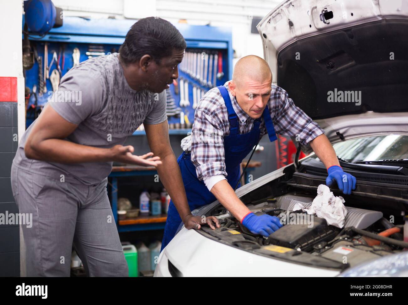 Two car mechanic diagnosing auto engine problem in service Stock Photo ...