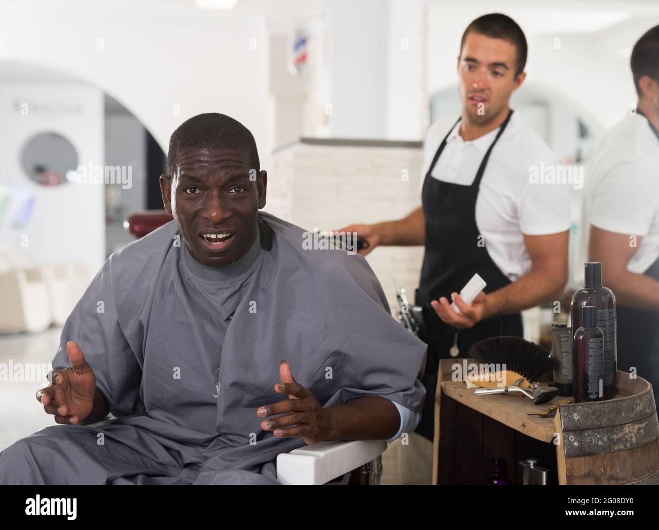 African man unpleasantly surprised by haircut Stock Photo - Alamy
