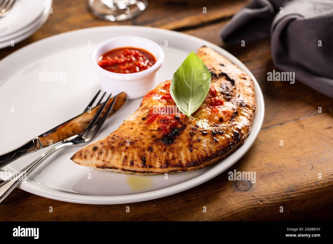 Traditional Italian cheese calzone with marinara sauce Stock Photo - Alamy