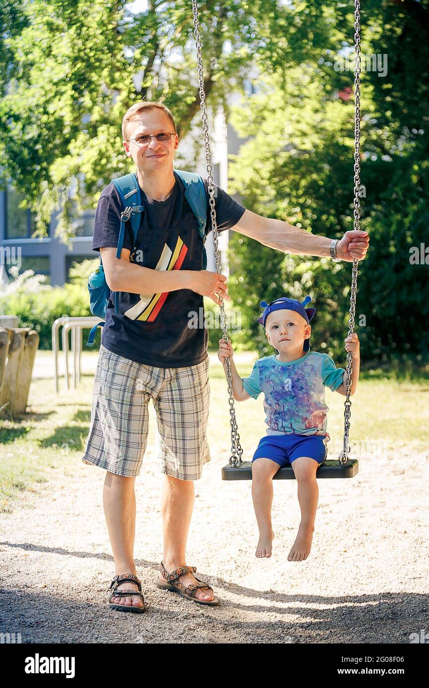 Father pushing son hi-res stock photography and images - Alamy