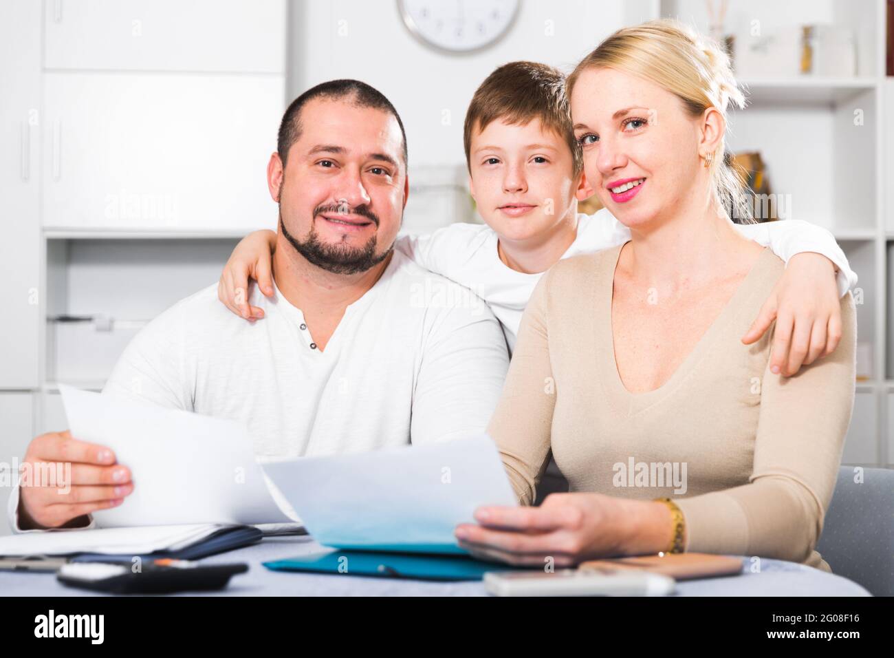 Smiling family with papers Stock Photo - Alamy