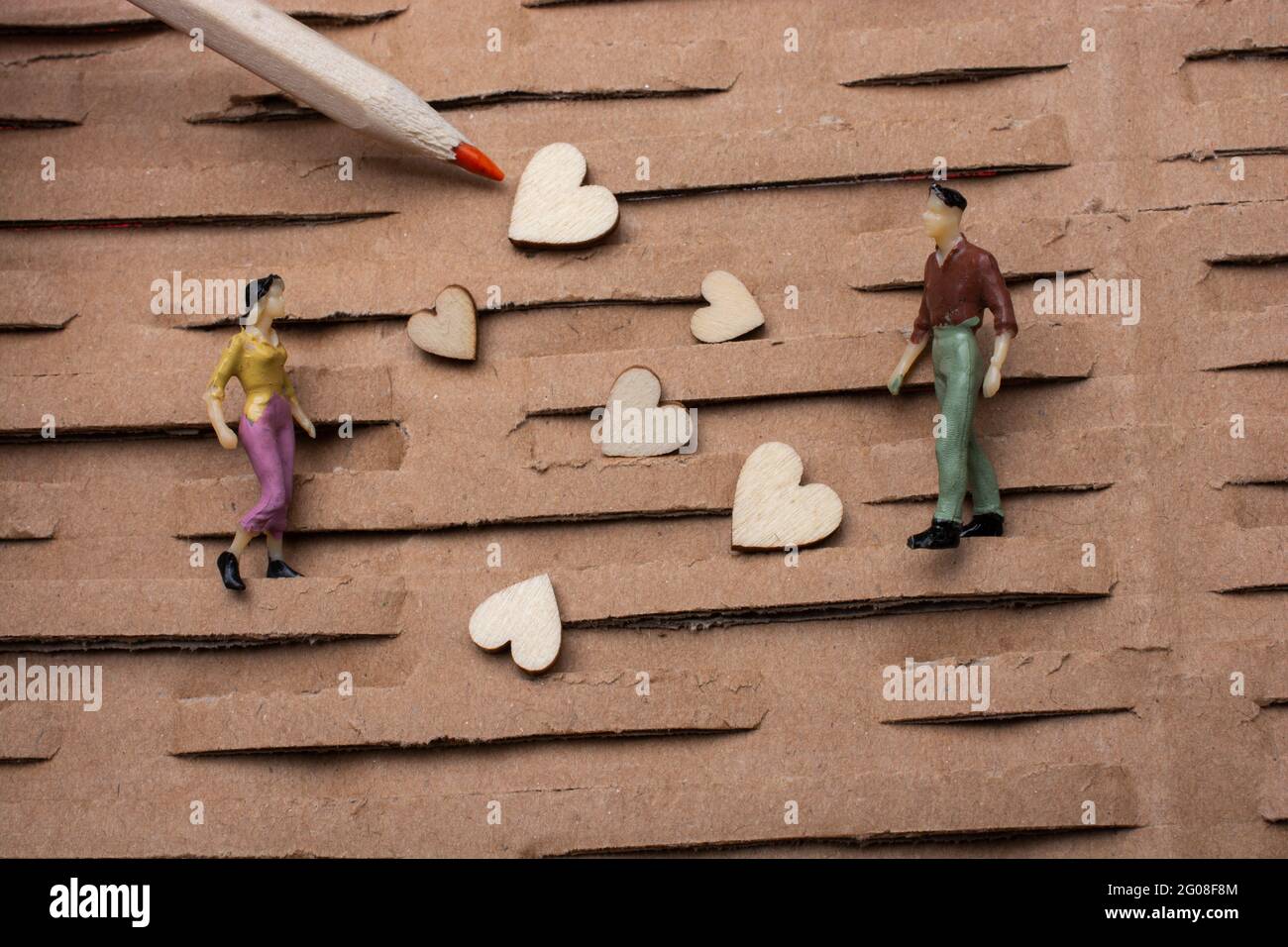Tiny figurine of man and woman miniature model and heart as love ...