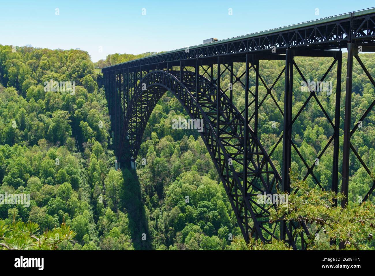 Center arch of the New River Gorge Bridge with a passing truck for ...