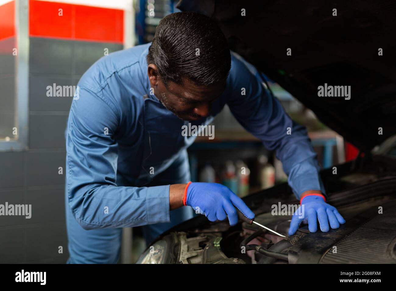 Professional man car mechanician repairing car in auto repair Stock ...